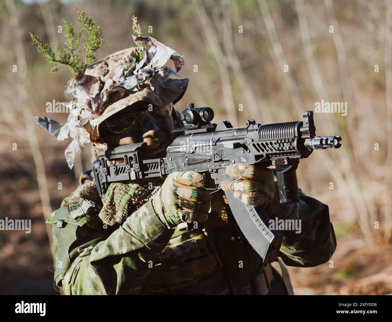 Airsoft military game player in camouflage uniform with armed assault ...