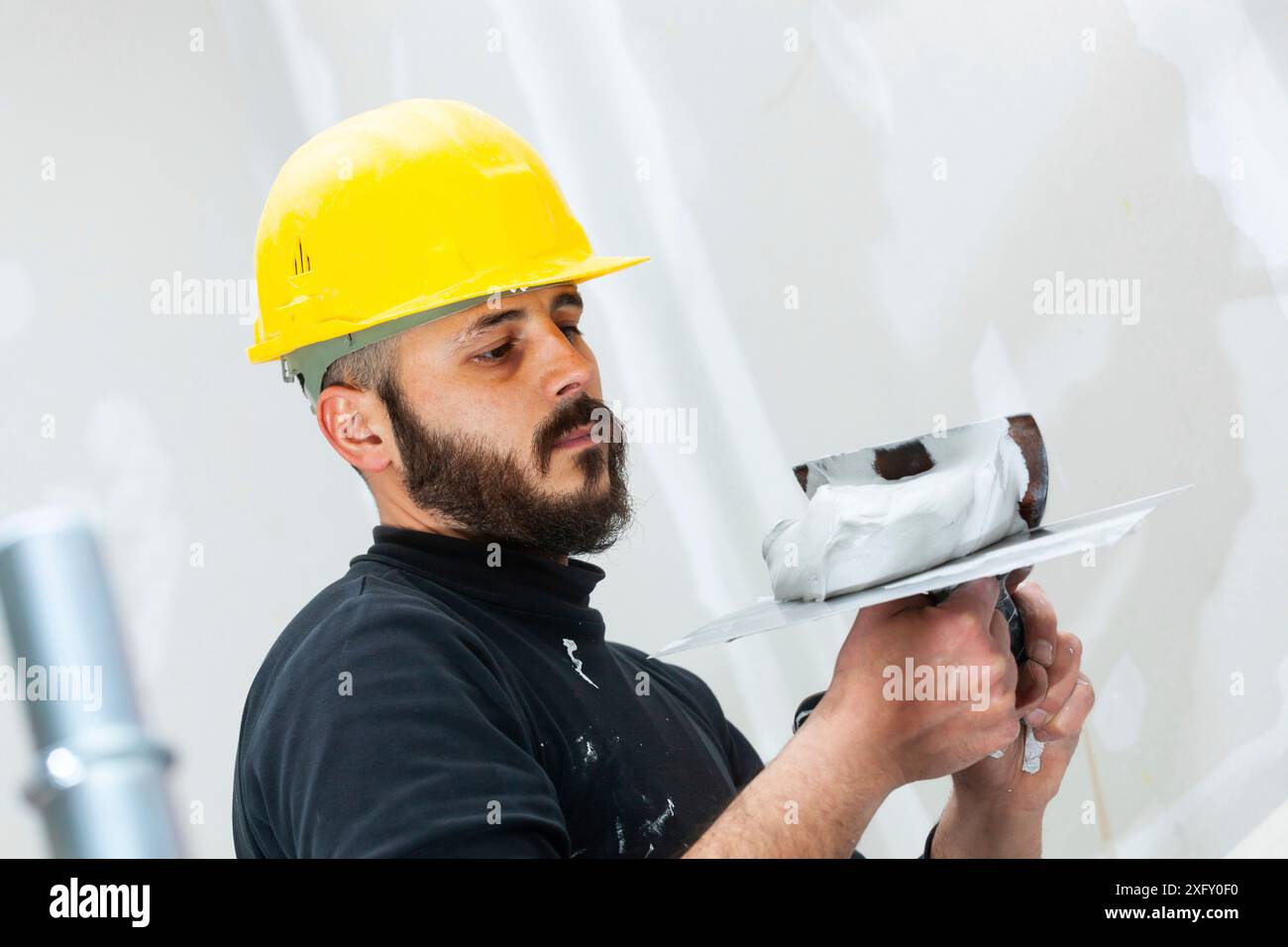 Interior construction, worker plastering gypsum board wall Stock Photo ...