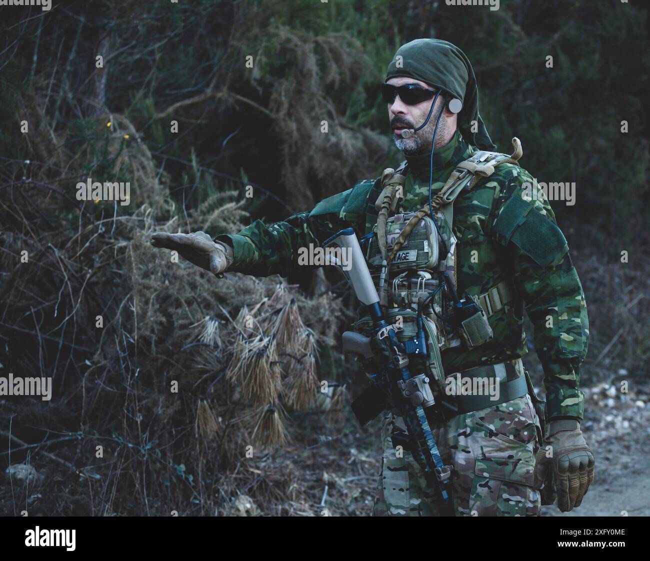 Airsoft military game player in camouflage uniform with armed assault ...