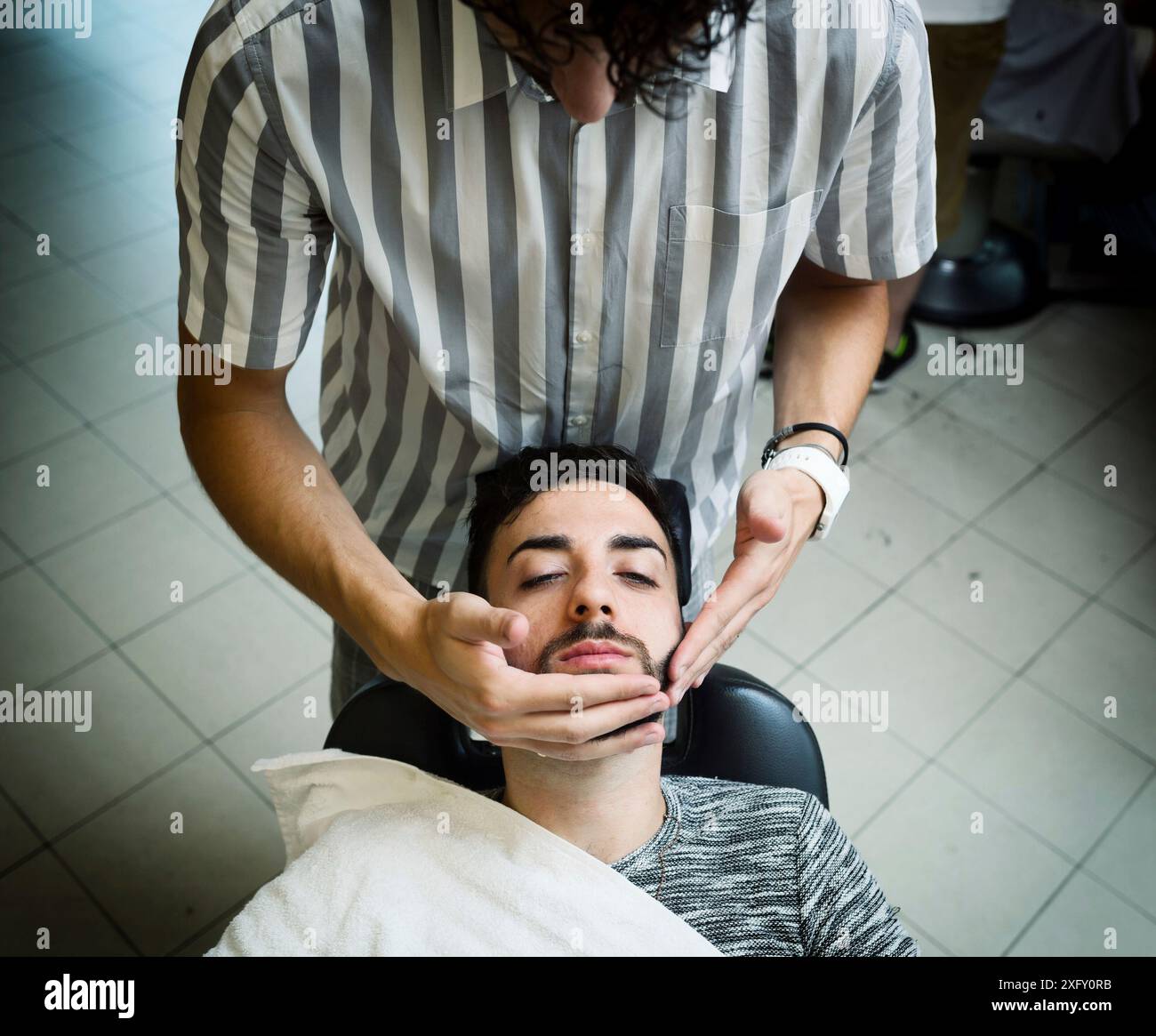 Traditional ritual of shaving the beard in a old style barber shop ...