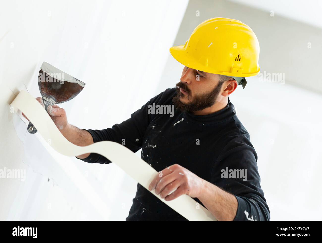Interior construction, worker plastering gypsum board wall Stock Photo ...