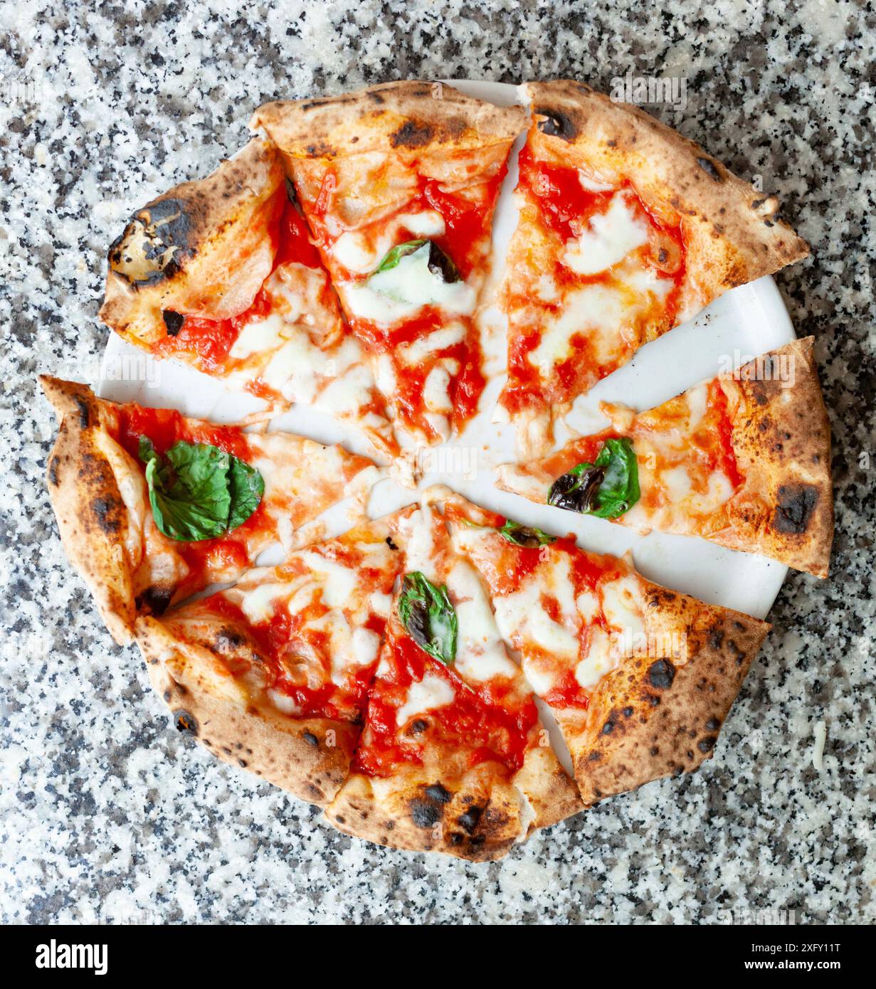 Top view of slices of pizza margherita on marble table Stock Photo - Alamy