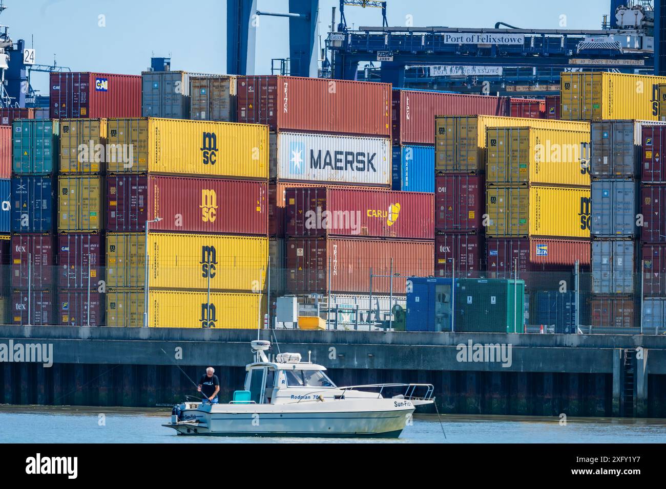 Man fishing by the dock. Global trade, imports and exports. Shipping ...