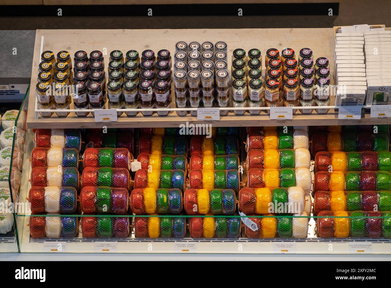 A display of colorful plastic containers with a variety of flavors. The ...