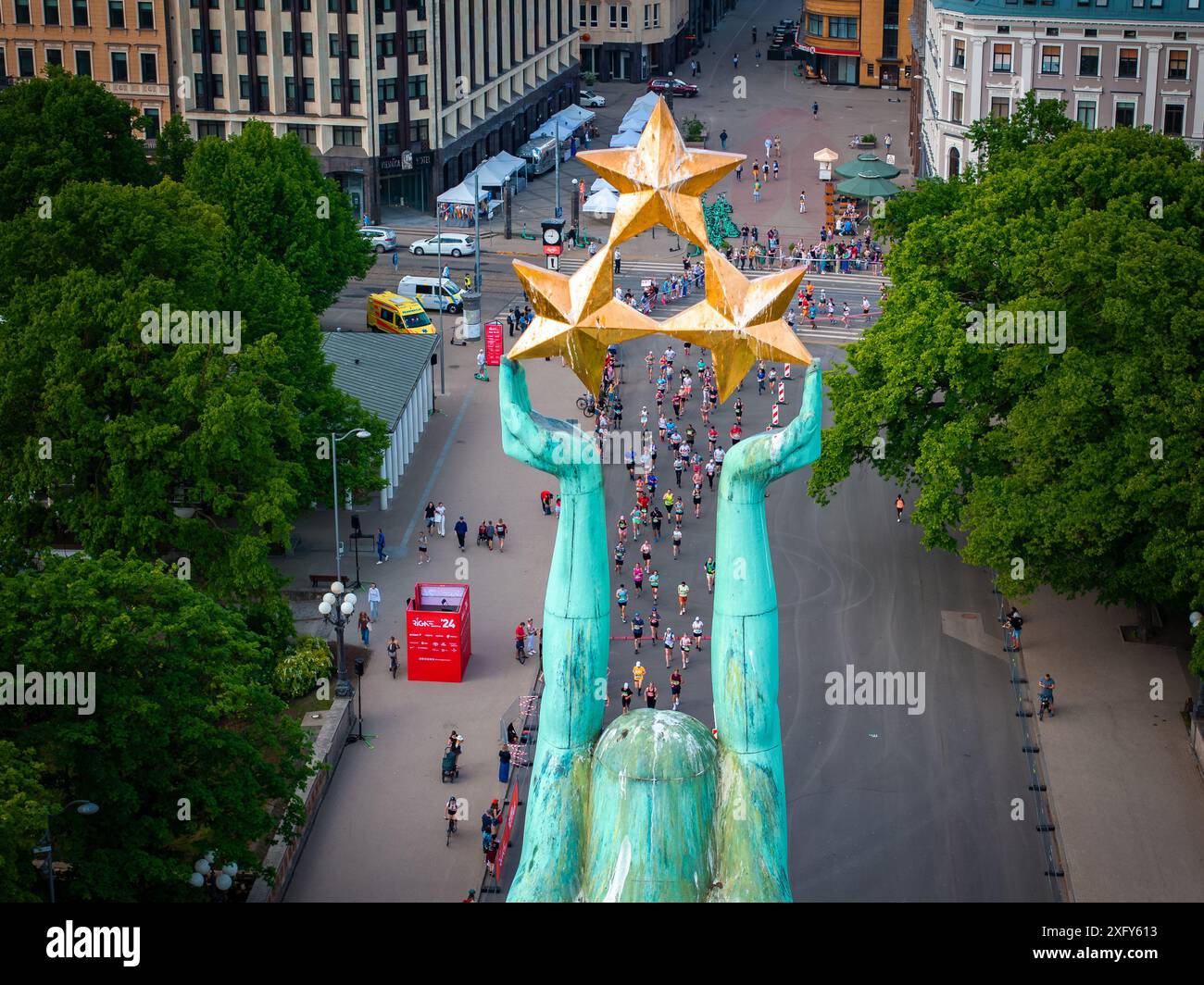 Aerial View of Runners Passing the Freedom Monument in Riga, Latvia ...