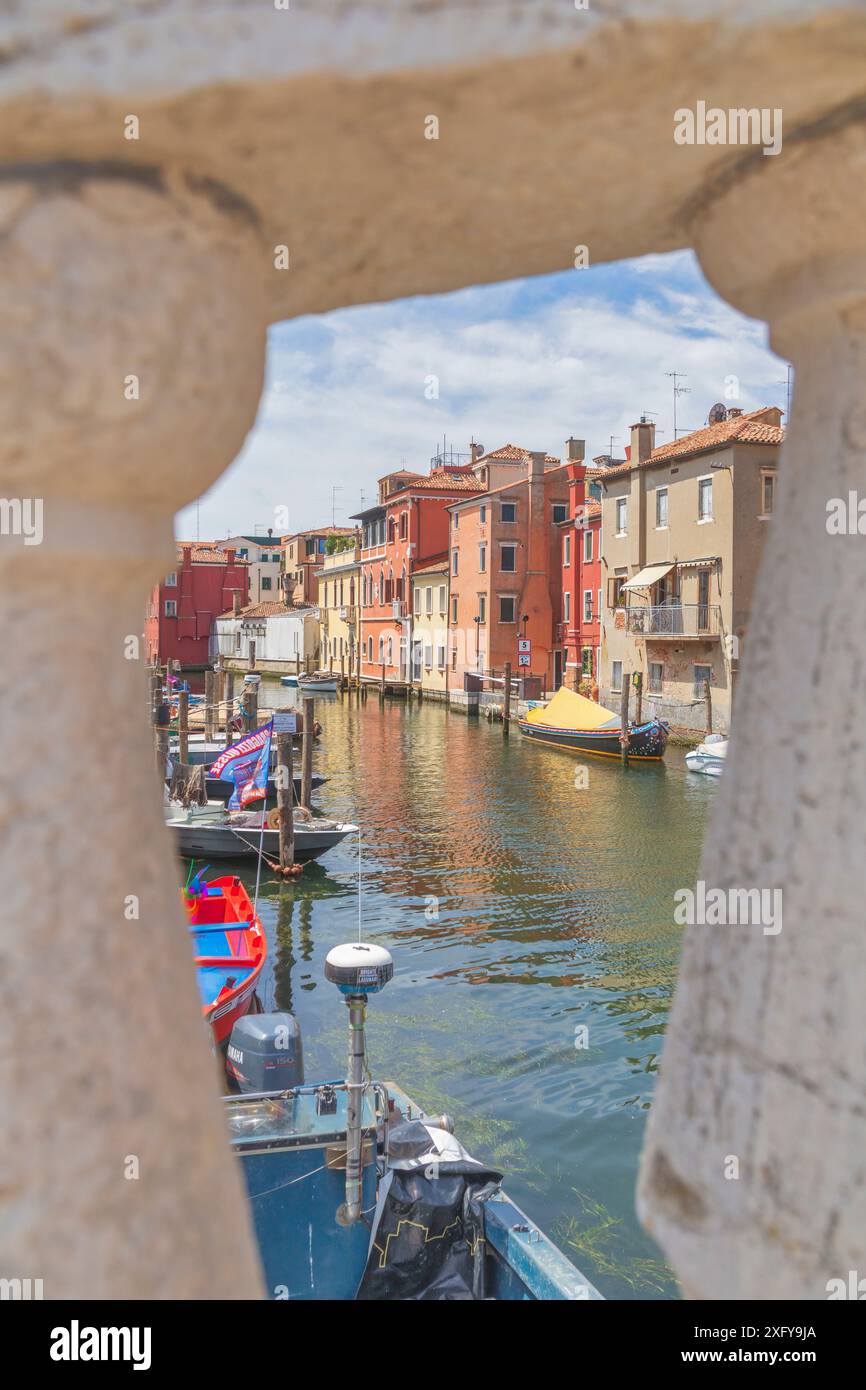 The multicolored facades of the buildings on the Canal Vena, Chioggia ...