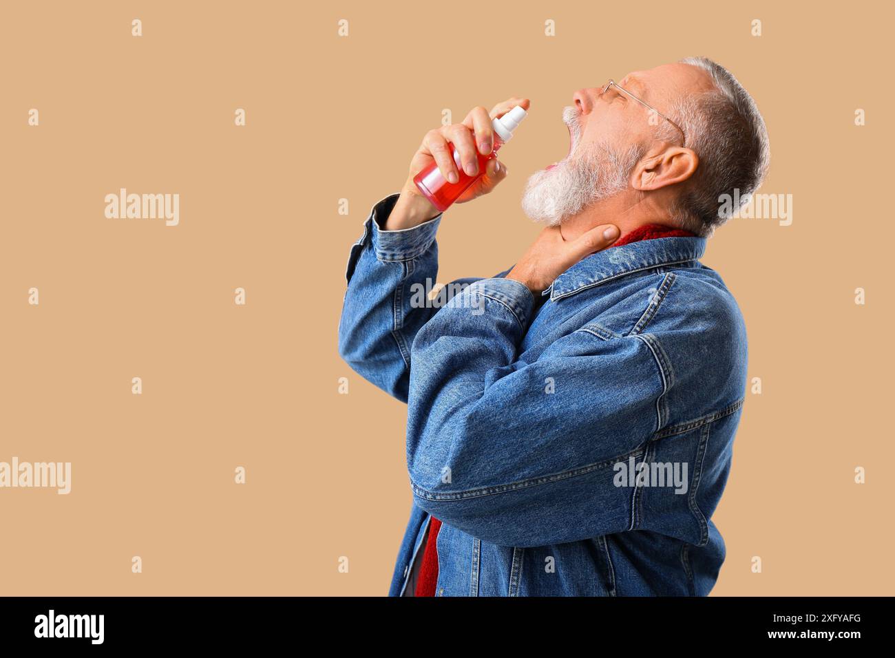 Old man with sore throat using medical spray on beige background Stock ...