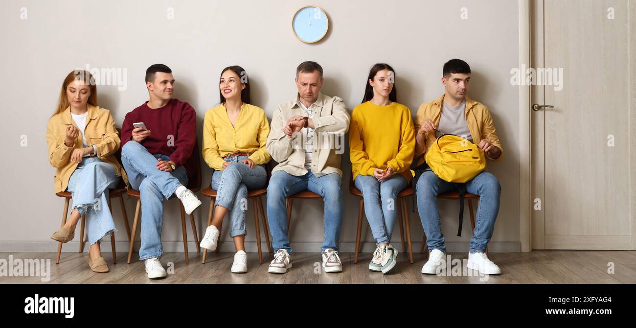 People waiting for their turn in hall Stock Photo - Alamy