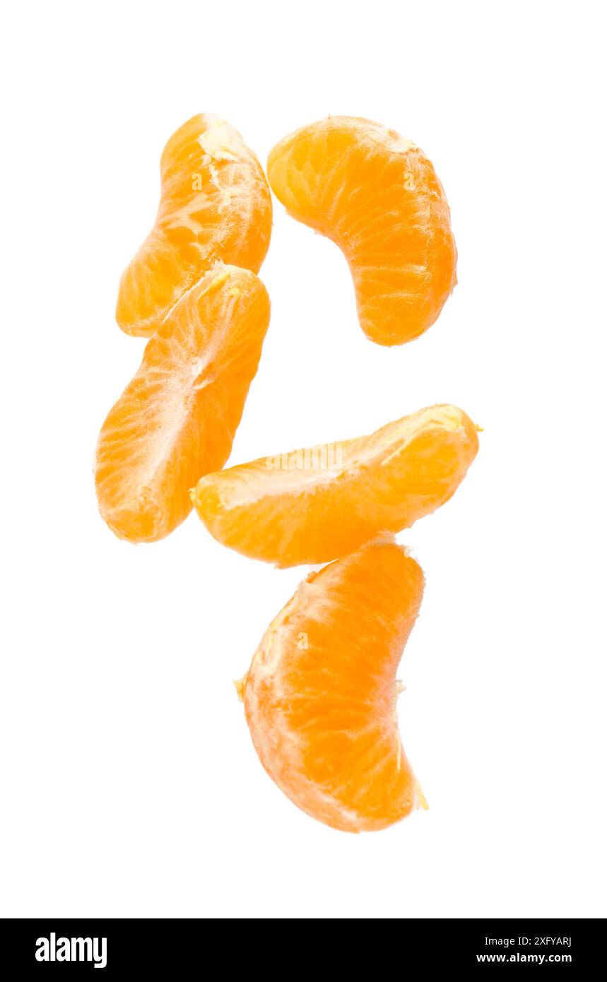 Flying segments of fresh tangerine on white background Stock Photo - Alamy