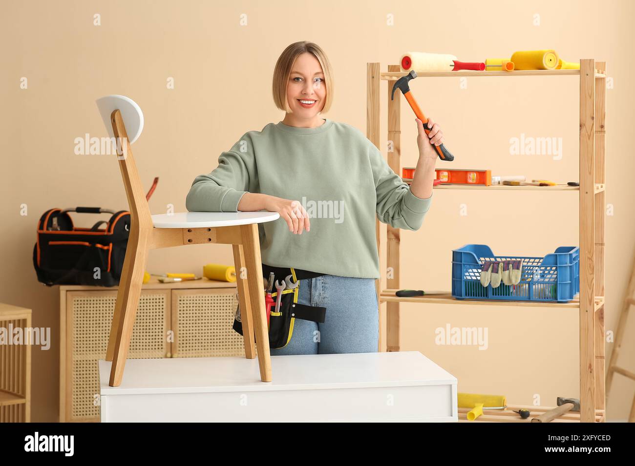 Female carpenter making chair at home Stock Photo - Alamy