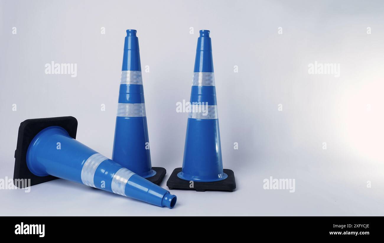 Road traffic safety equipment. Realistic blue traffic cones and yellow ...