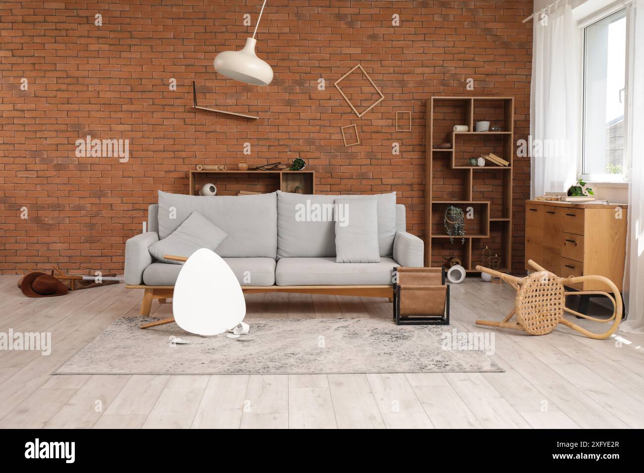 Interior of damaged living room with sofa and overturned table after ...