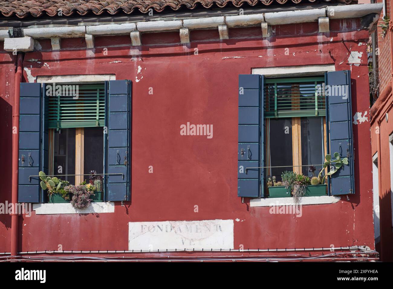 red house with blue shutters Stock Photo - Alamy