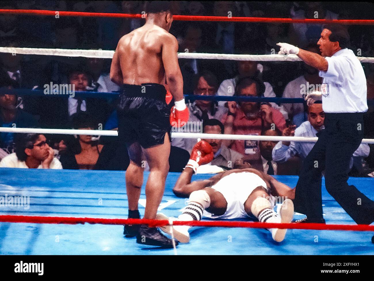 Mike Tyson knocks out Michael Spinks in the first round of their ...