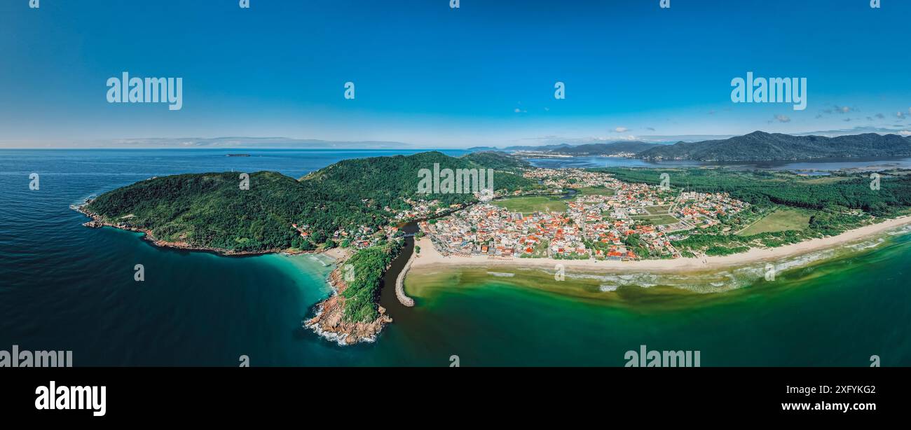Panoramic view of ocean coastline with beach, mountains and town in ...