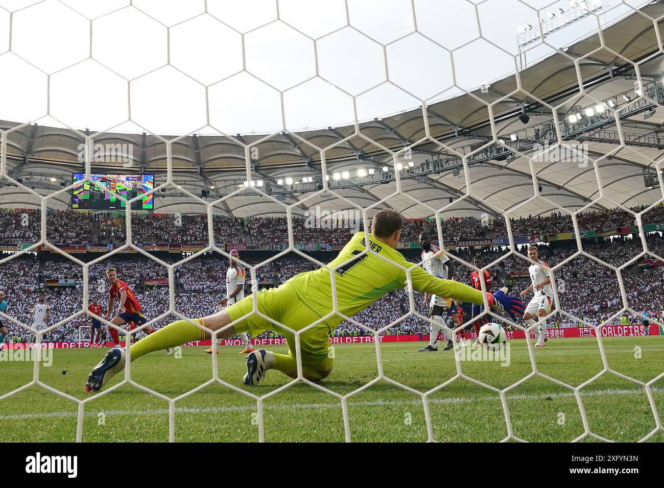 Spain’s Dani Olmo (left) scores their side's first goal of the game ...