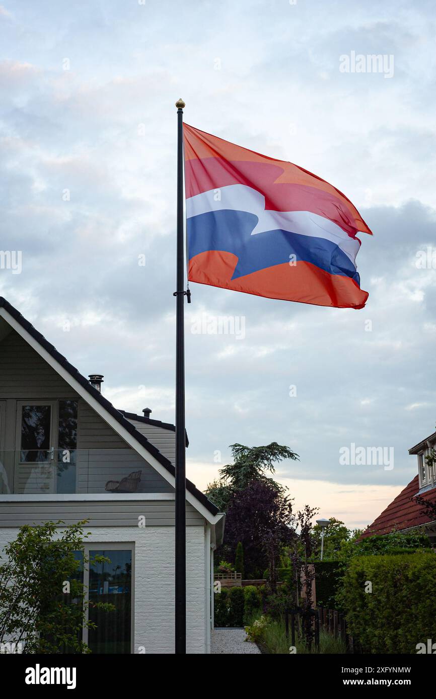 Waving Dutch soccer flag with the national tri color on orange ...