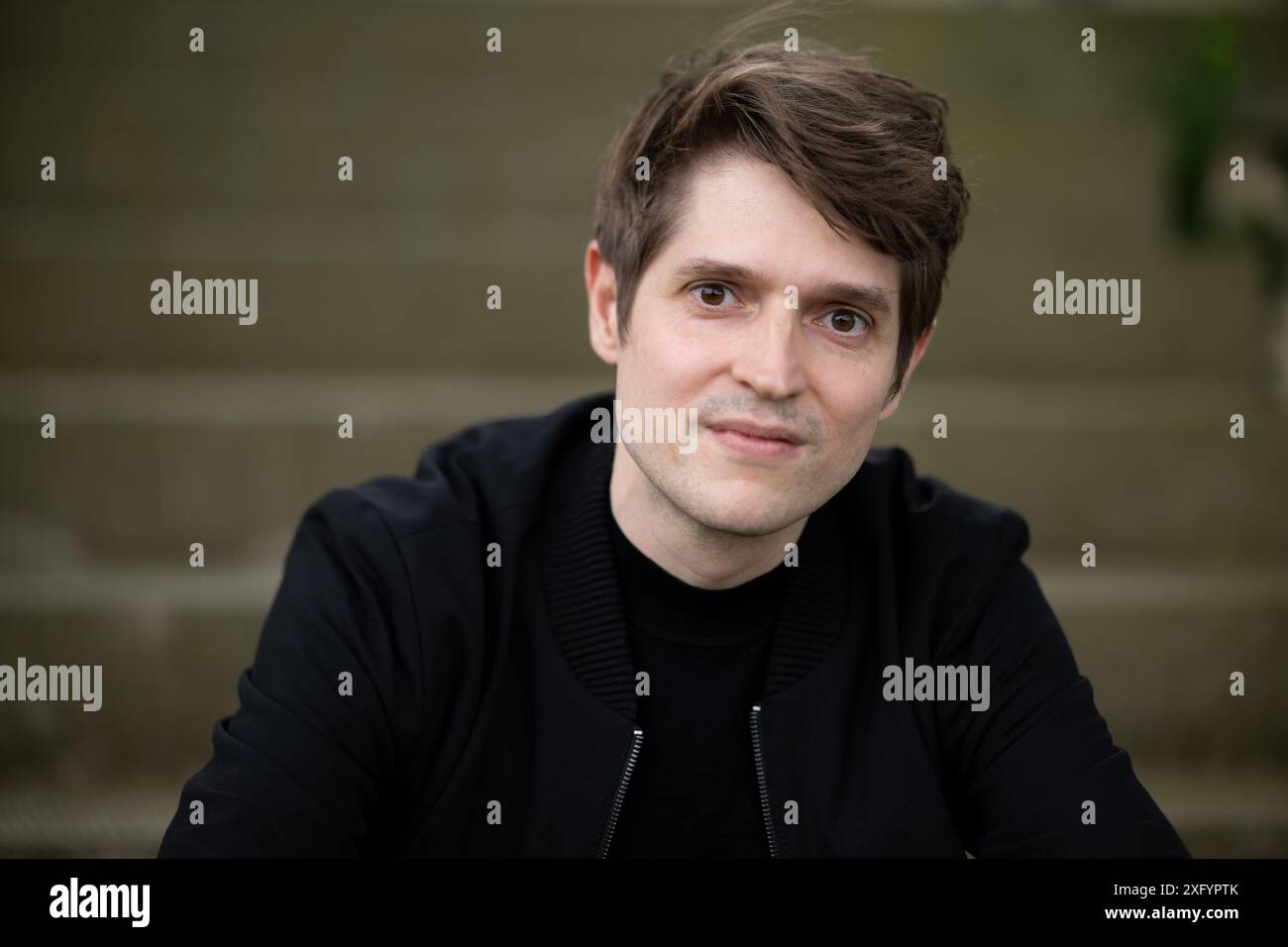 Potsdam, Germany. 05th July, 2024. Writer Benedict Wells sits in front ...