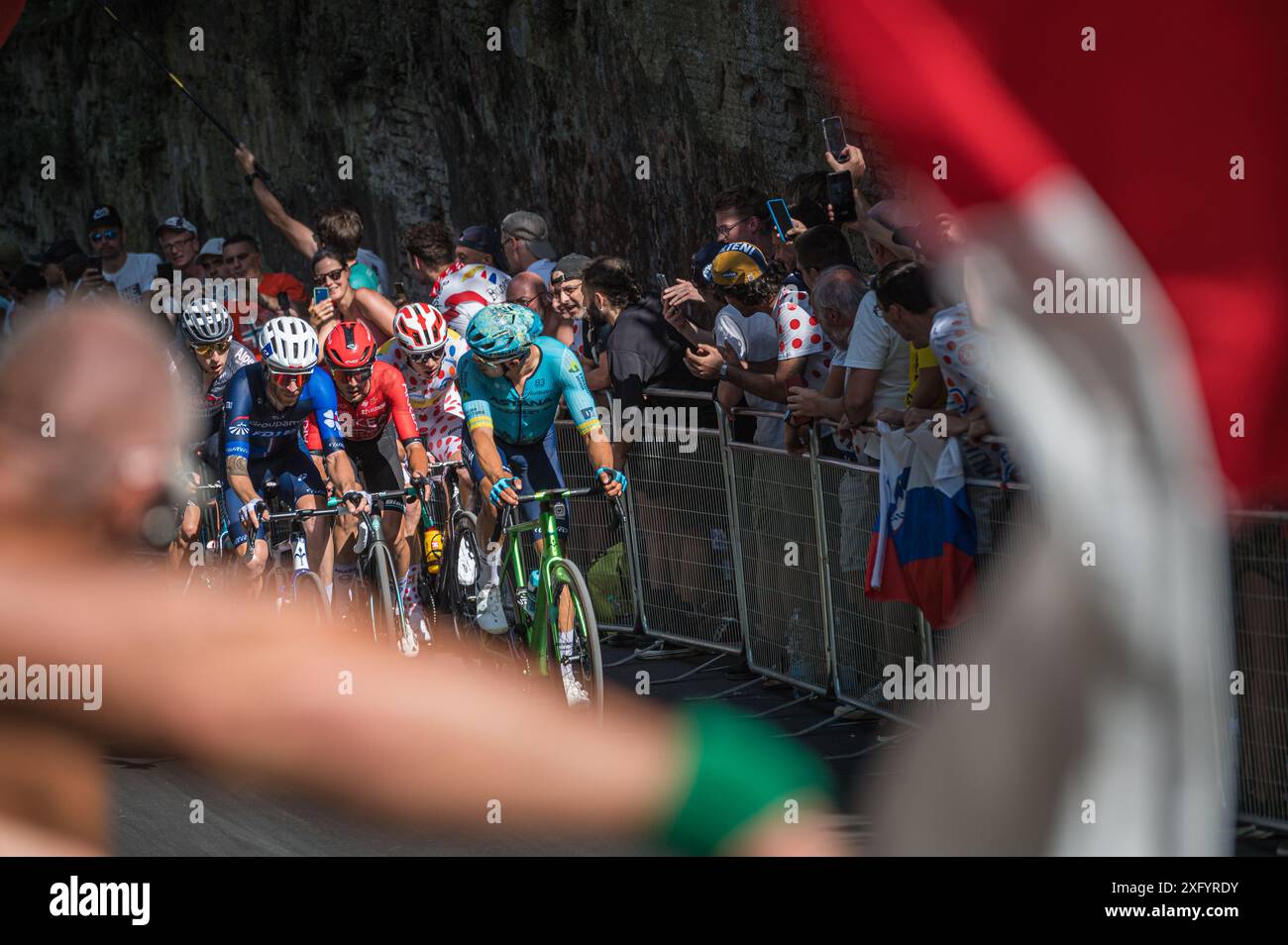 The cyclists racing through a crowd of spectators in Bologna. Stage 2 ...