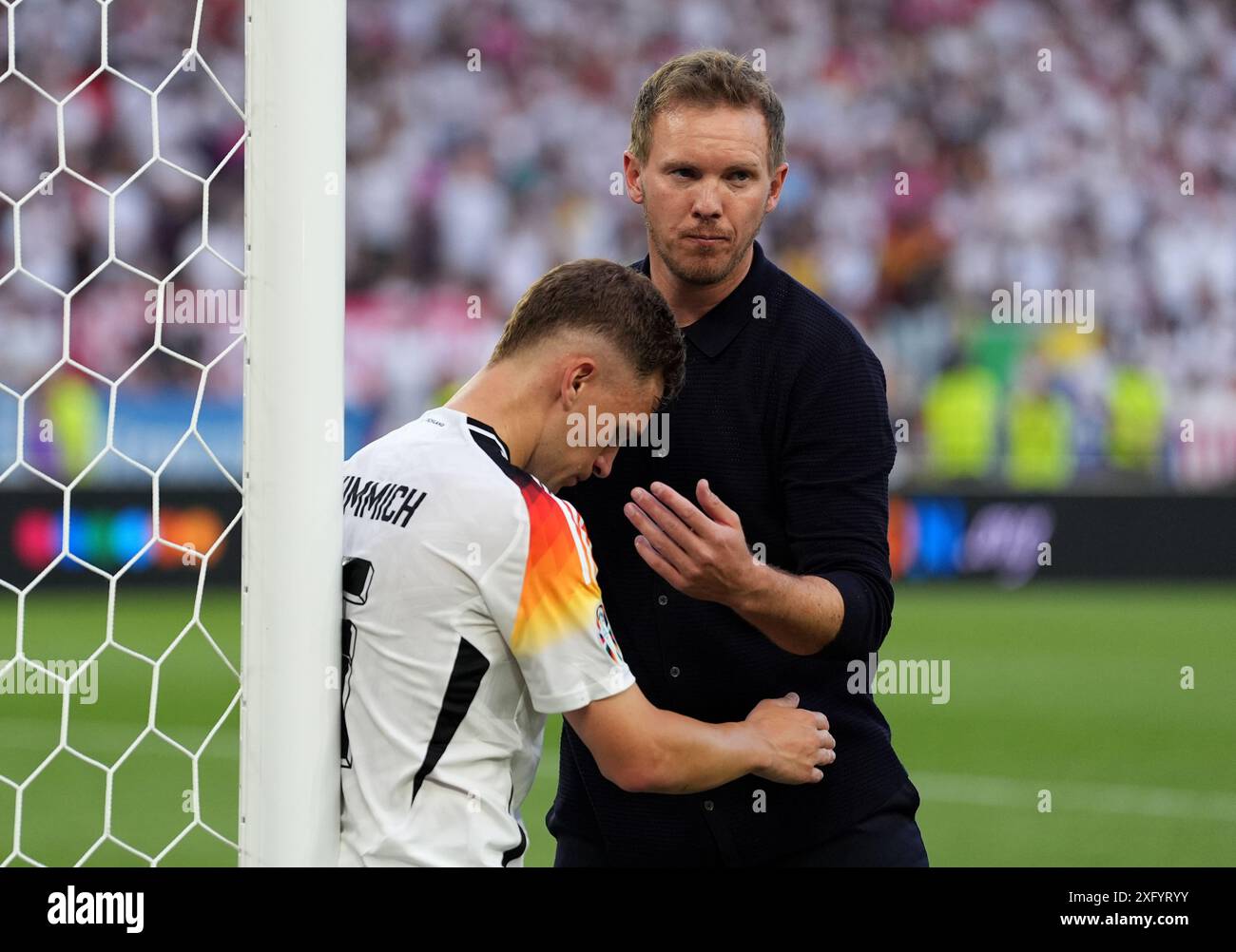 Germany's Joshua Kimmich is consoled by manager Julian Nagelsmann after ...