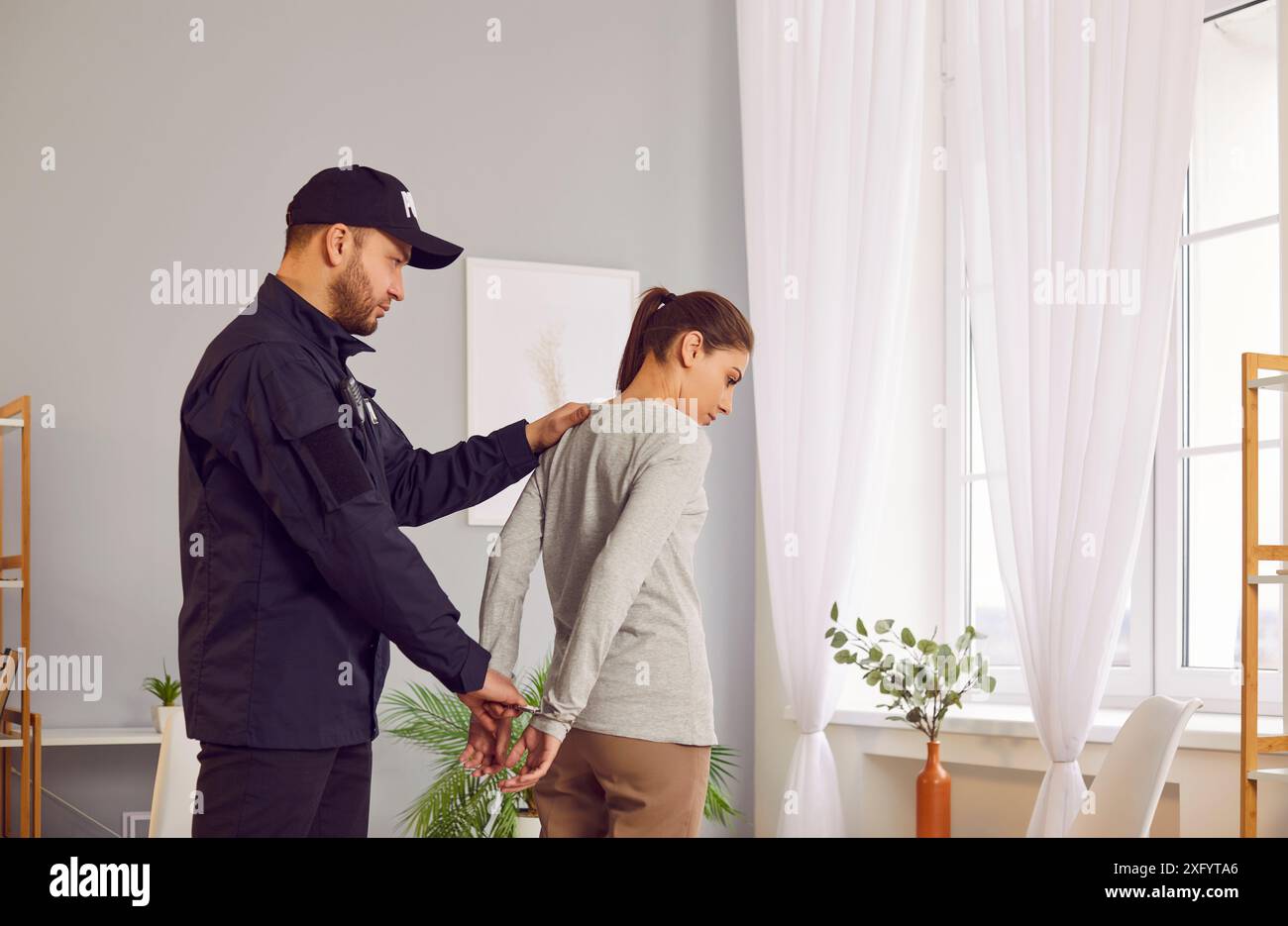 Policeman arresting woman hi-res stock photography and images - Alamy