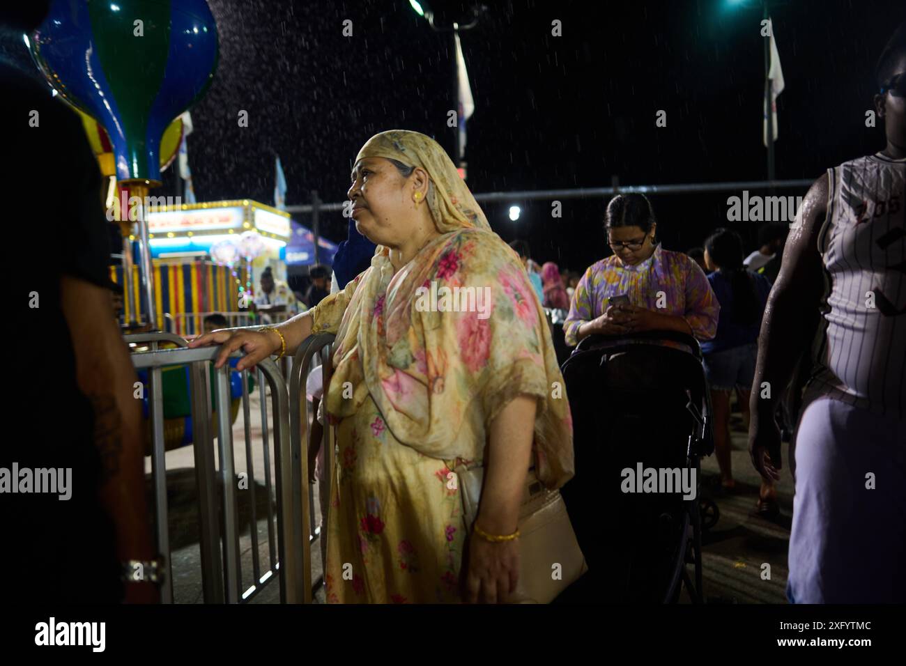 New York, New York, USA. 4th July, 2024. A woman stands in the rain in ...
