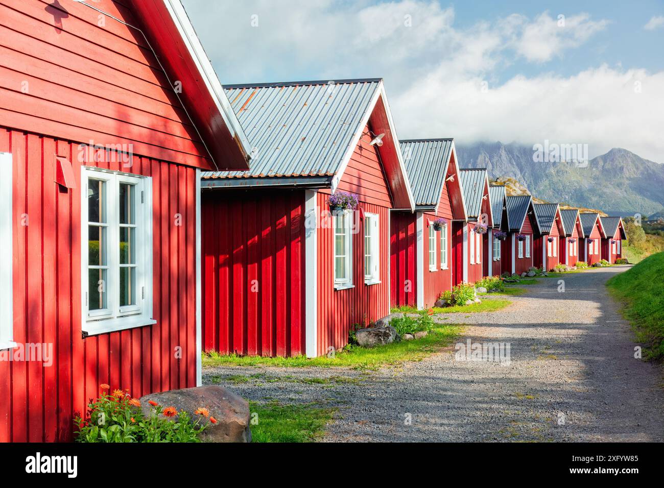 Row of traditional red huts for tourists with scenic mountain views and ...