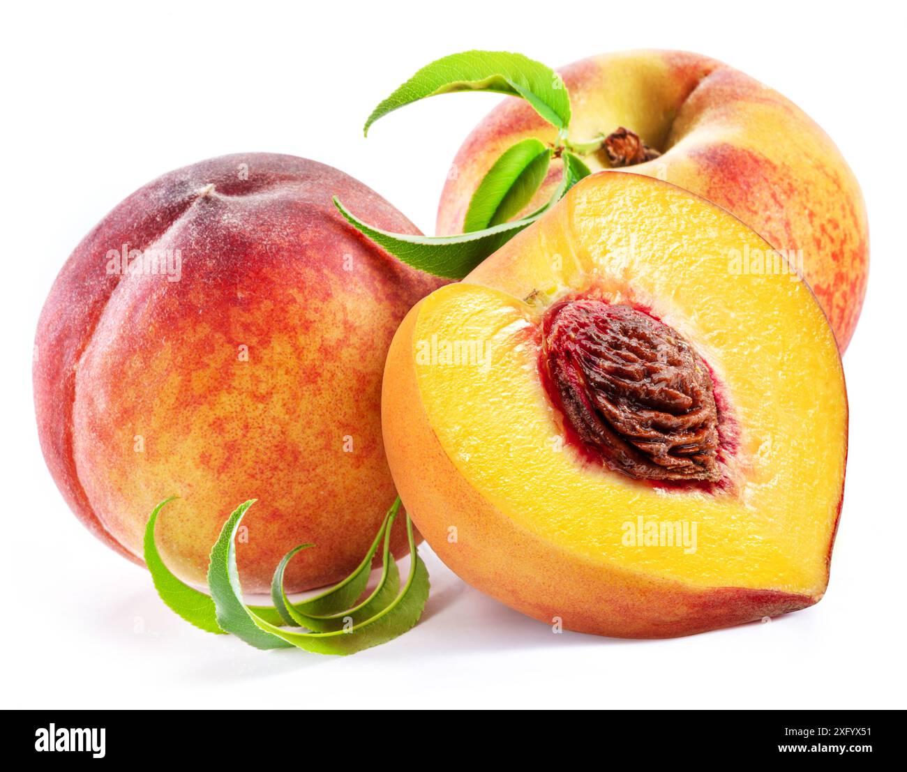Ripe juicy peach half and two peaches with green leaves isolated on ...