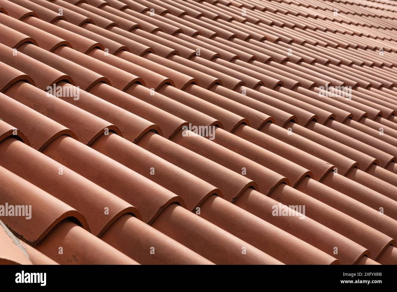 Red corrugated roof tile element on a house on a sunny day. Shingles ...