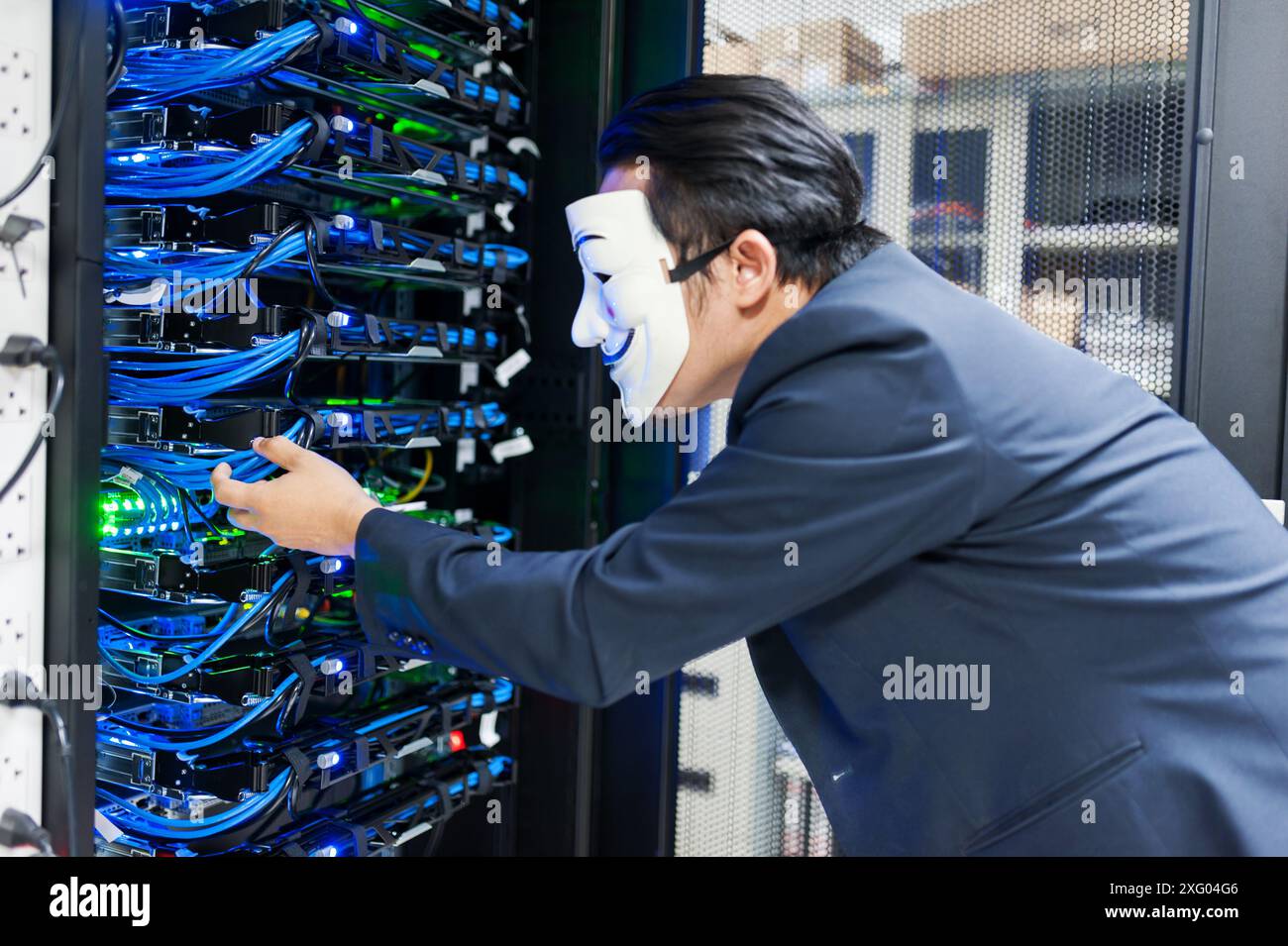 Masked Hacker in Computer Server room Concept .Editorial photo Stock ...