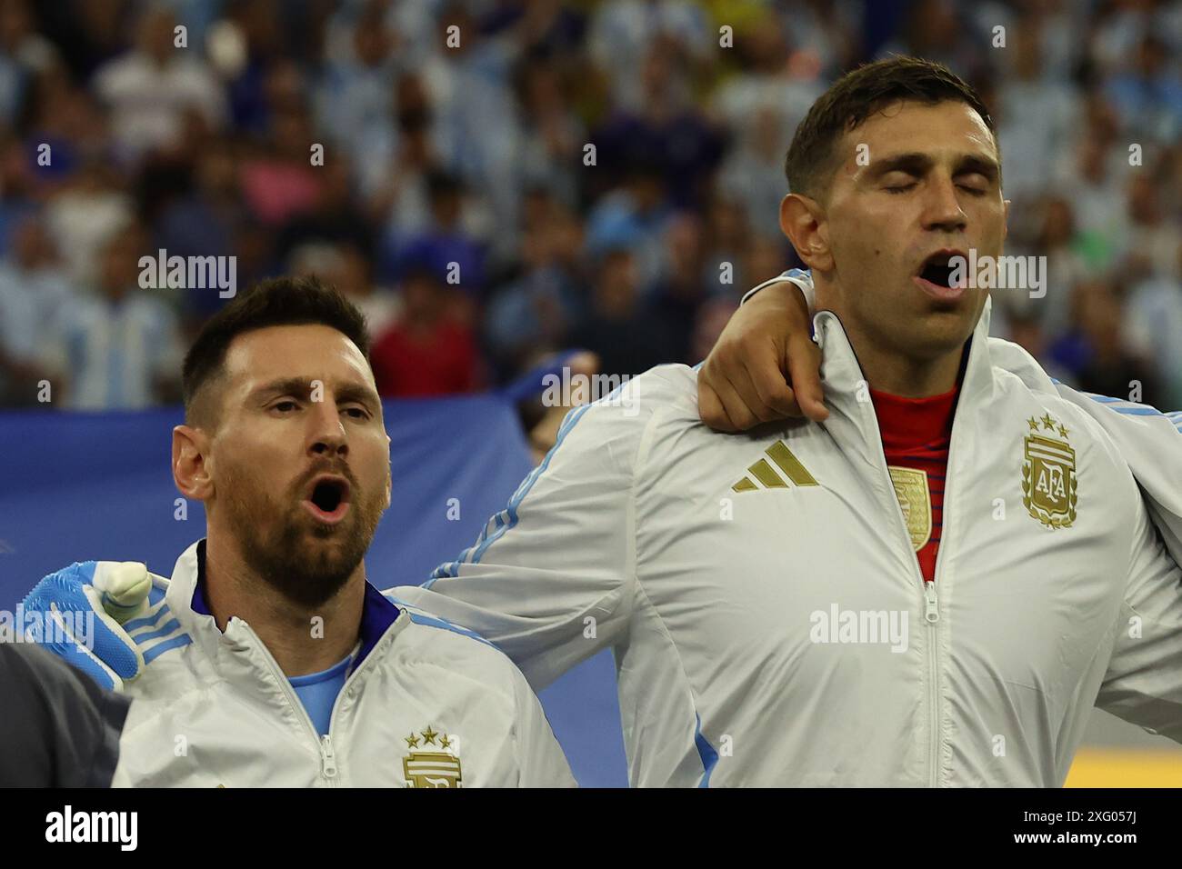 Argentina's forward Lionel Messi (L) and goalkeeper Emiliano Martinez ...