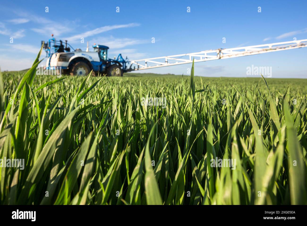Farmer using a self-propelled sprayer, using a fungicide, and/or a ...