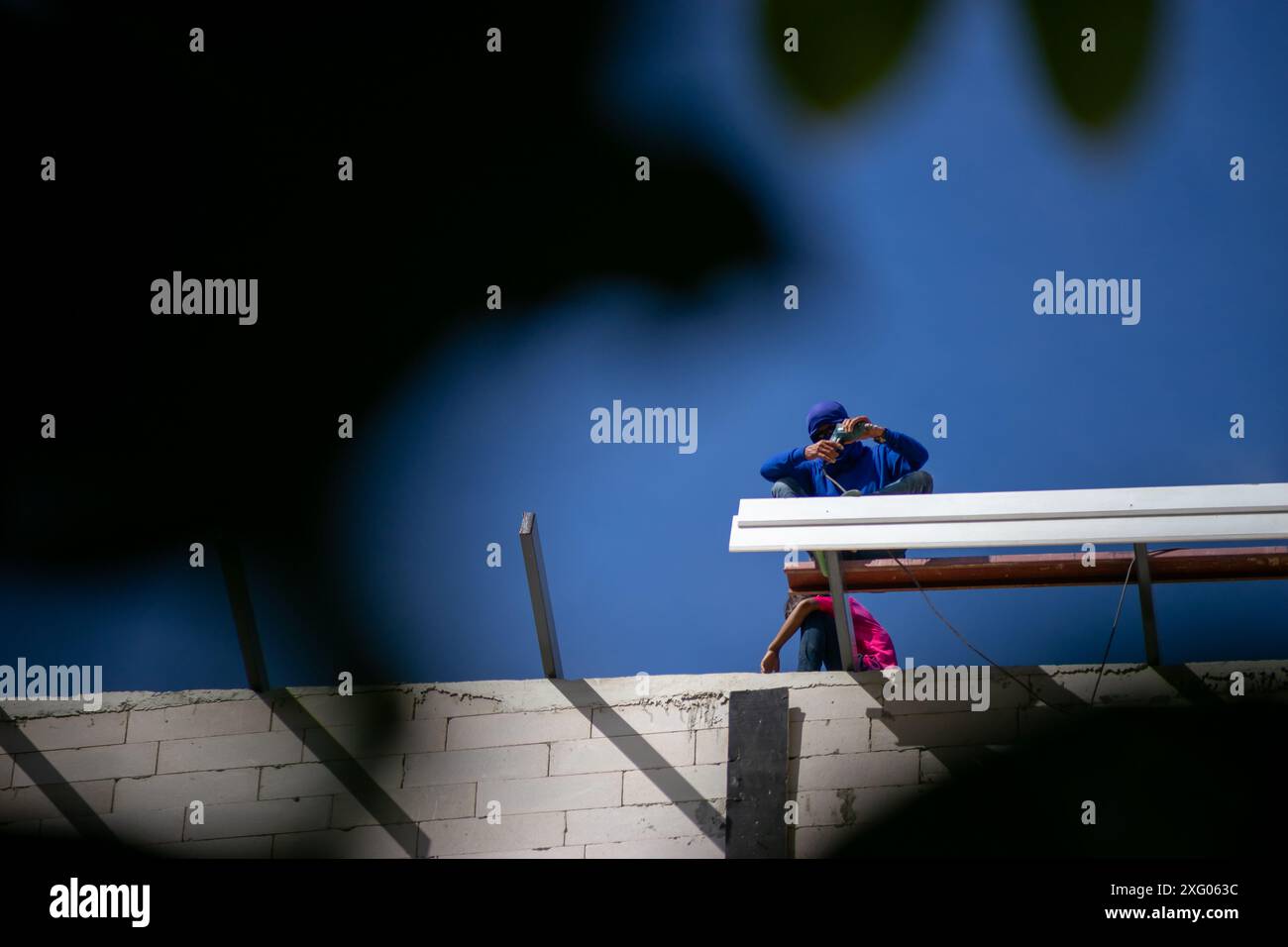 Working at heights without protective equipment Stock Photo - Alamy