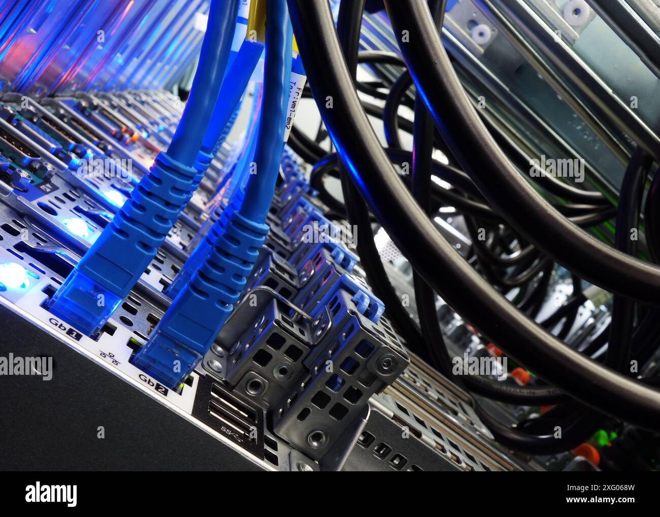 close up of network cables connected to server racks in data center ...