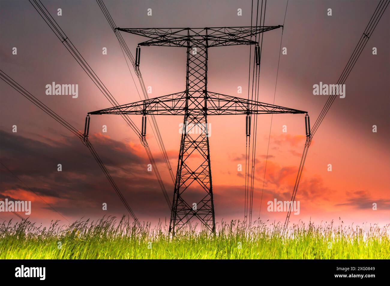 High-voltage power line leaving Cattenom nuclear power plant at sunset ...