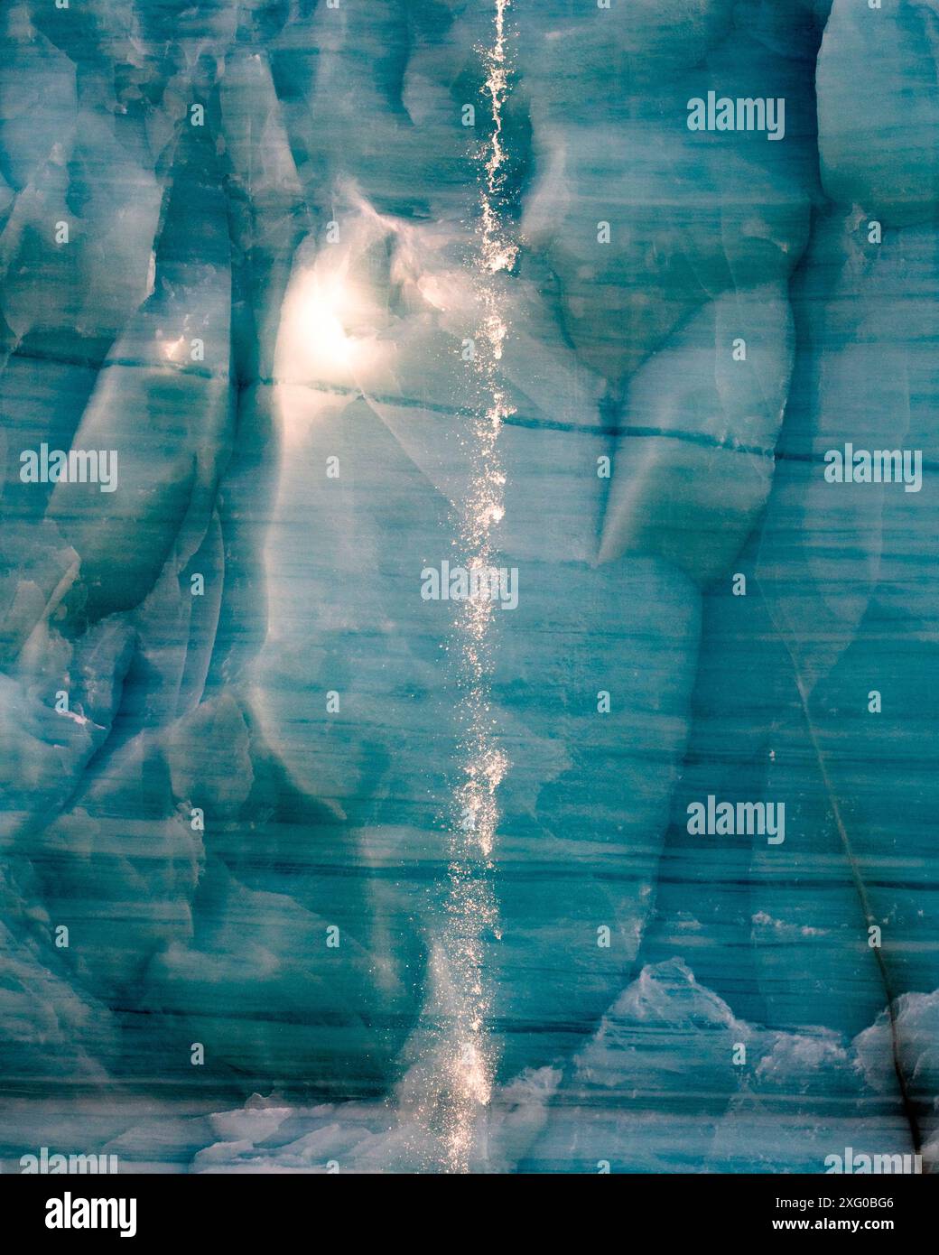 Light effect on a small waterfall falling from the top of the ...