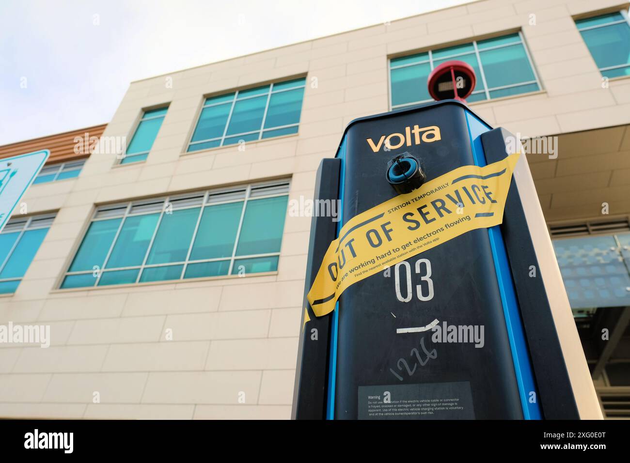 Volta public electric vehicle car charging station with yellow Temporarily Out of Service sign ...
