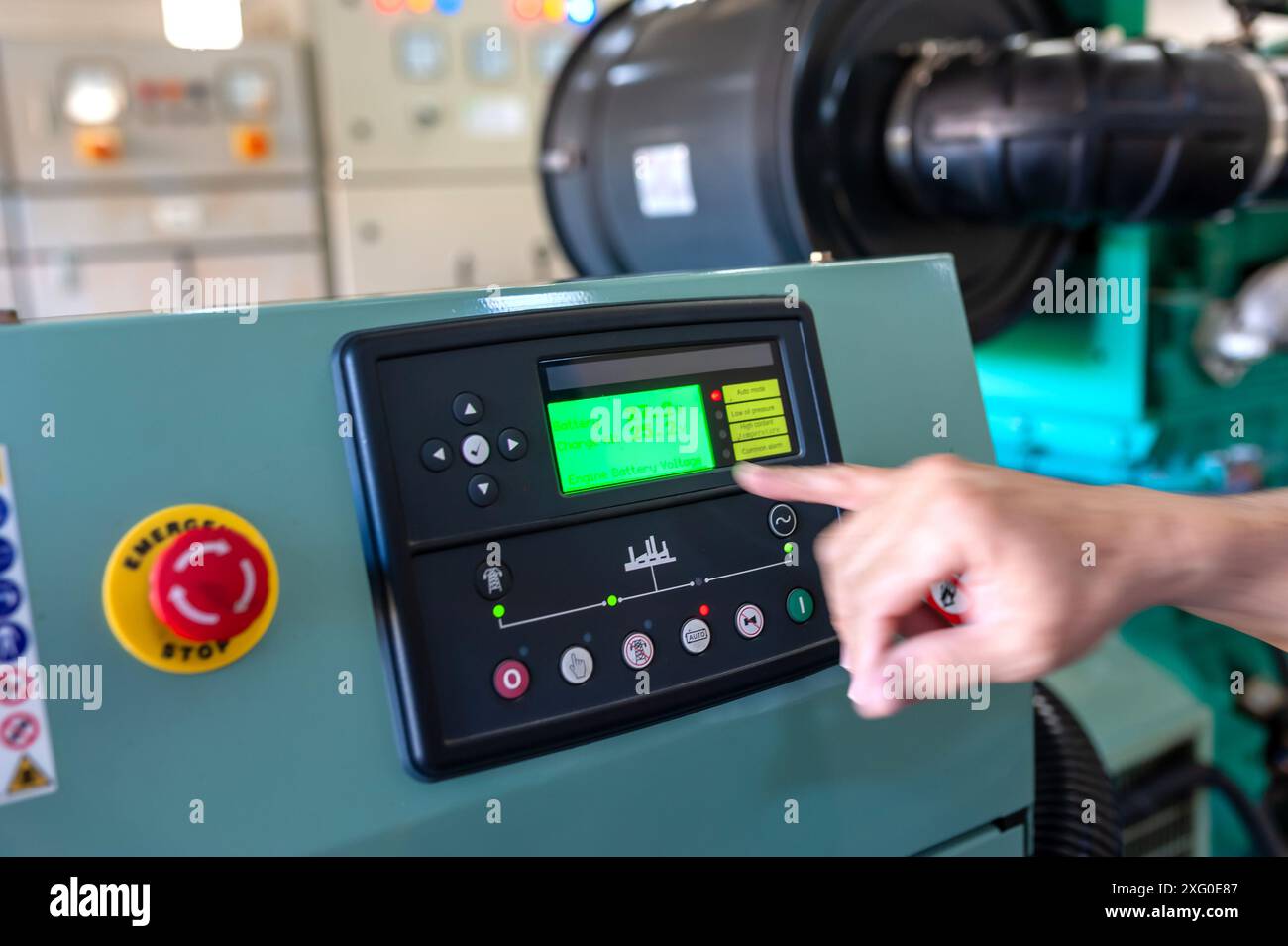 Close-up of the hands of a man operating a control panel in a factory ...