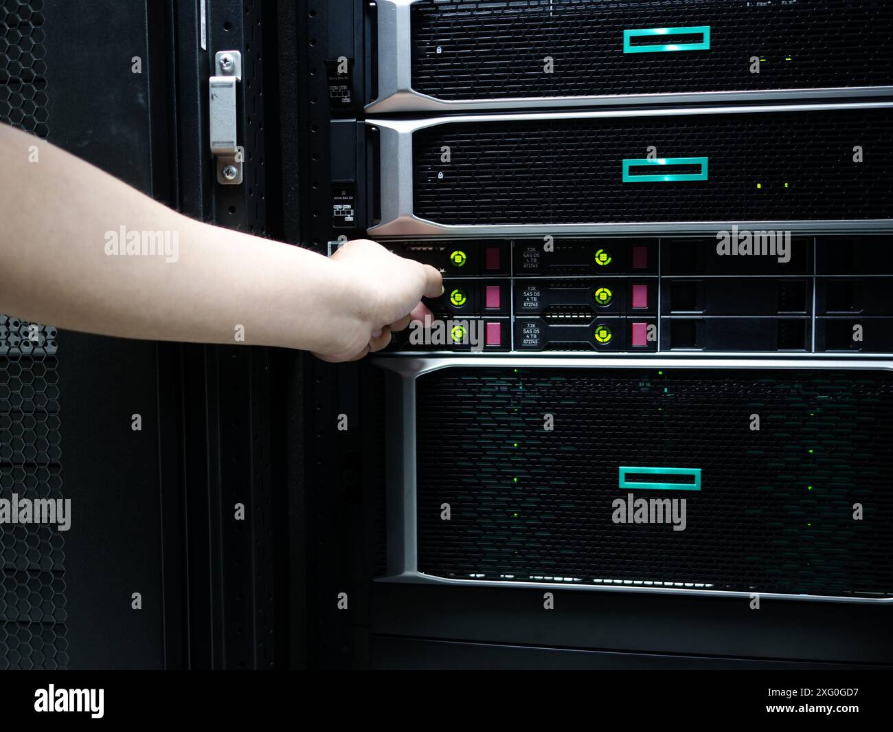 Man fixing server in data center room Stock Photo - Alamy