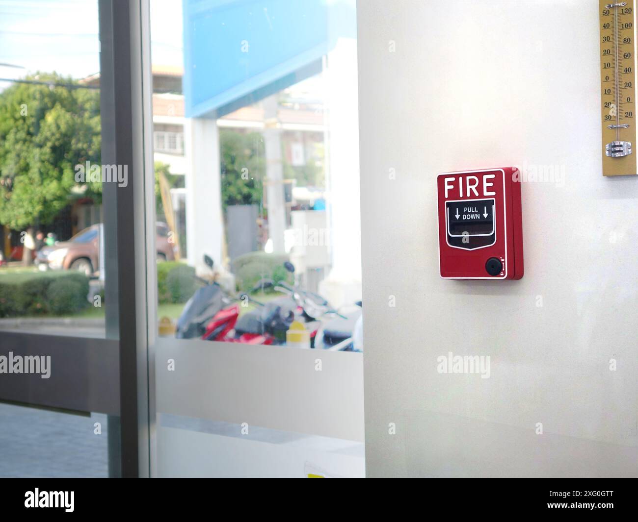 Fire bell pull sign in supermarket Stock Photo - Alamy