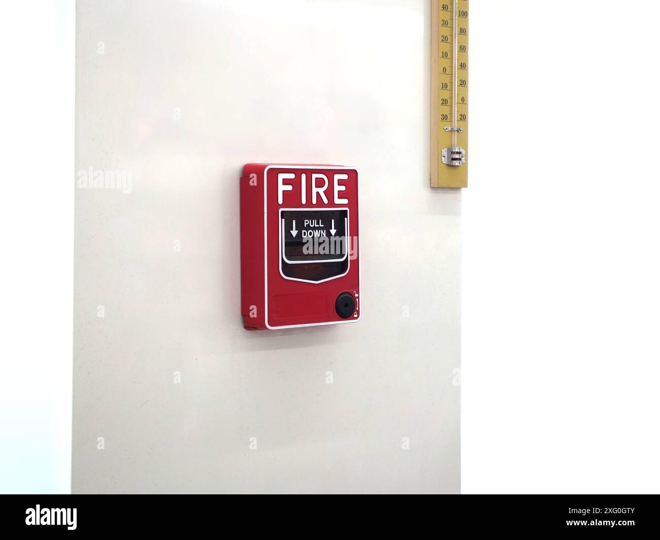 Fire bell pull sign in supermarket Stock Photo - Alamy