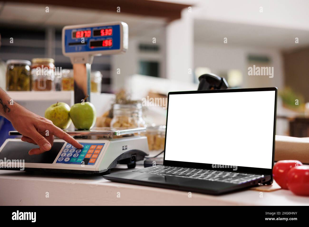 Digital laptop displaying white screen is positioned on checkout ...