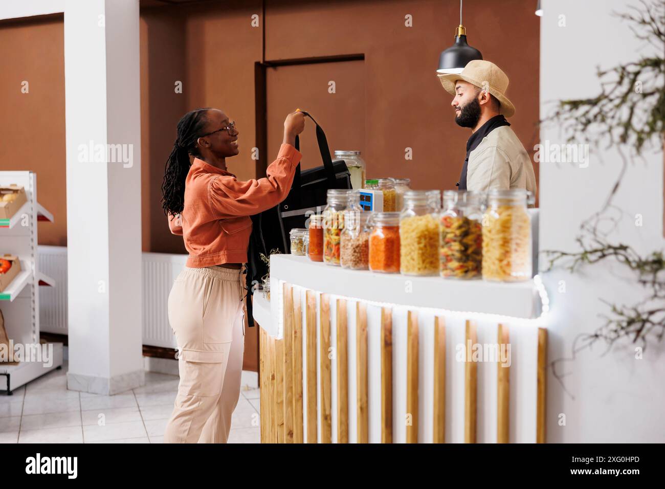 African american delivery woman preparing to leave eco friendly store ...