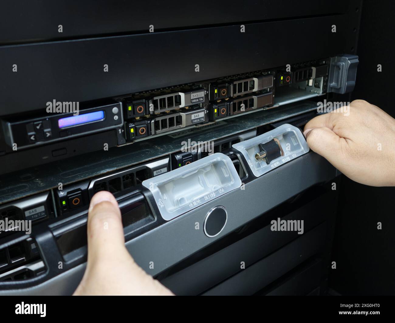 Man fixing server in data center room Stock Photo - Alamy