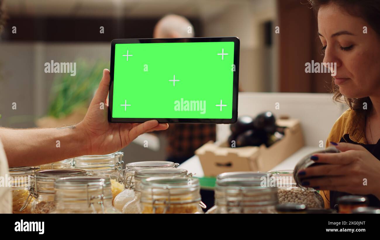 Man uses landscape mockup tablet in sustainable zero waste supermarket ...
