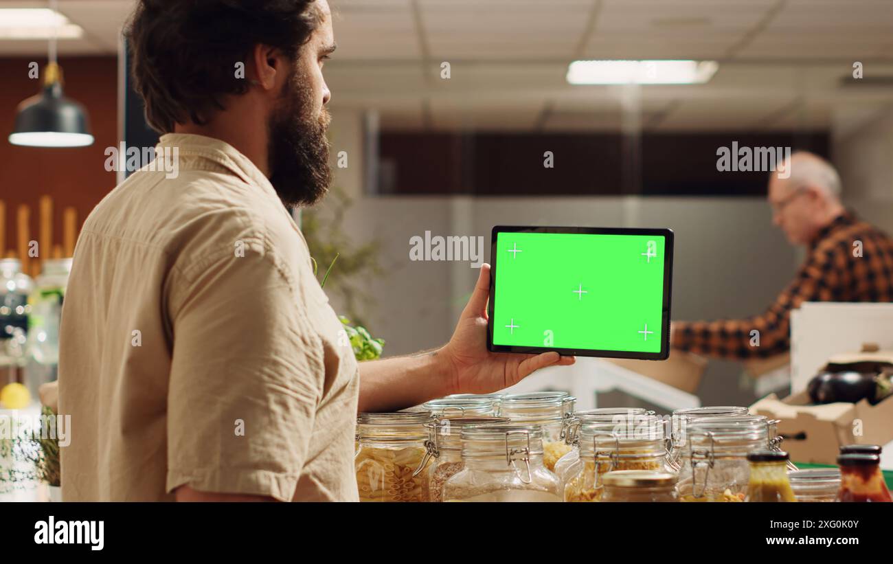 Customer using isolated screen tablet in zero waste supermarket to ...