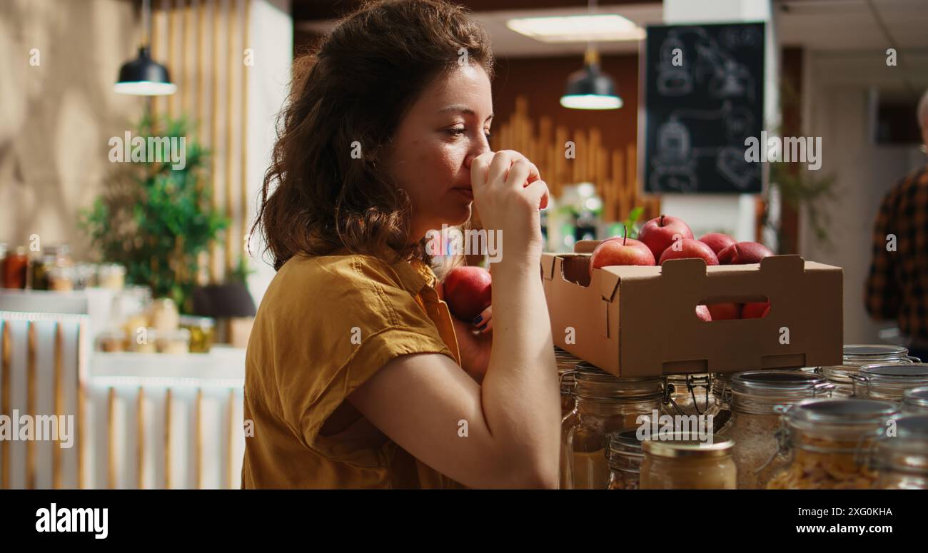 Client verifying apples in local bio food store are organic, feeling ...