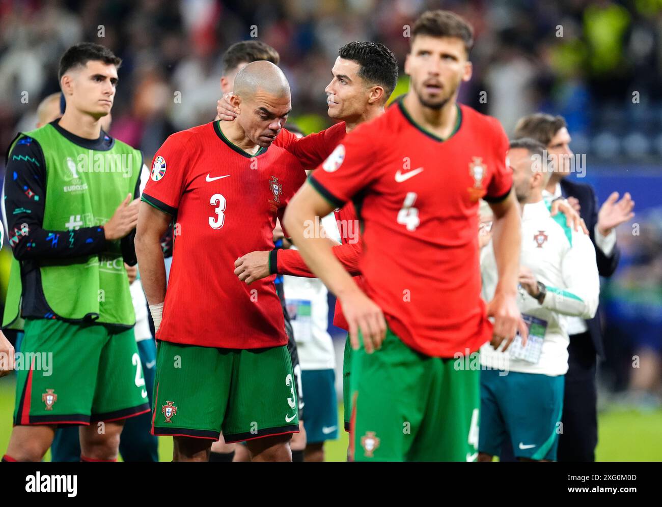 Portugal's Cristiano Ronaldo consoles team-mate Pepe (second left ...