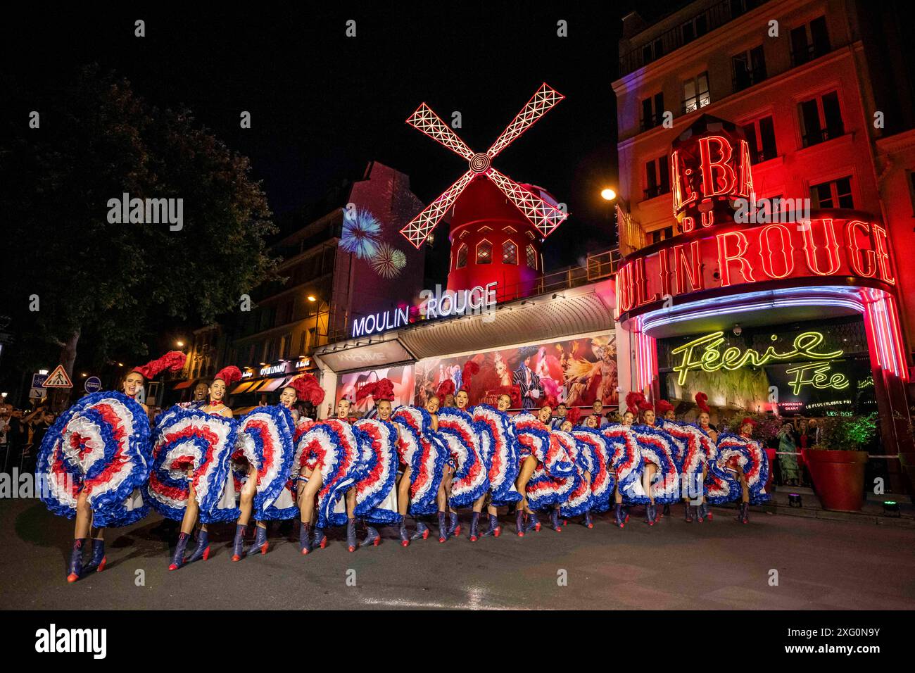 Dancers perform in front of the Moulin Rouge cabaret during the ...