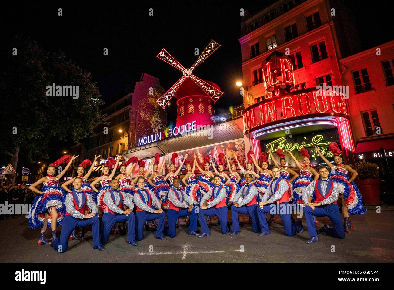 Dancers perform in front of the Moulin Rouge cabaret during the ...